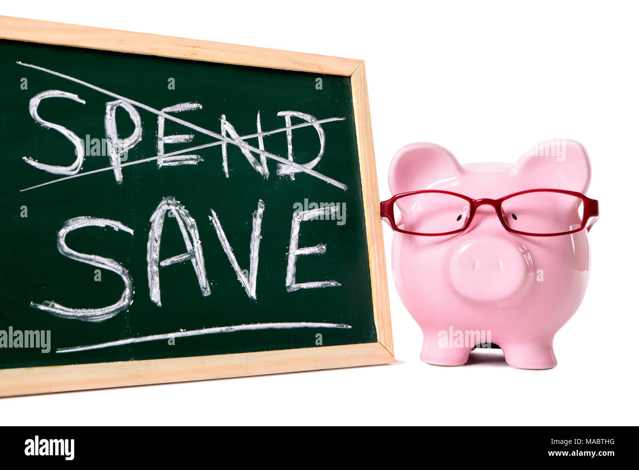 Pink piggy bank with glasses standing next to a blackboard with spend ...
