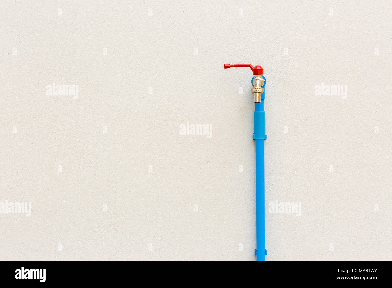 Faucet on cement wall Stock Photo - Alamy