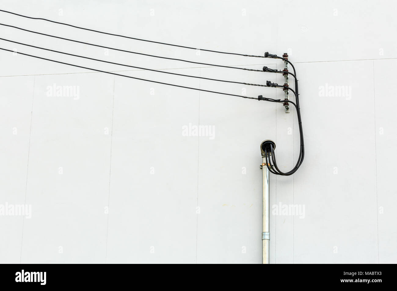 Wires and pipe on cement wall Stock Photo - Alamy