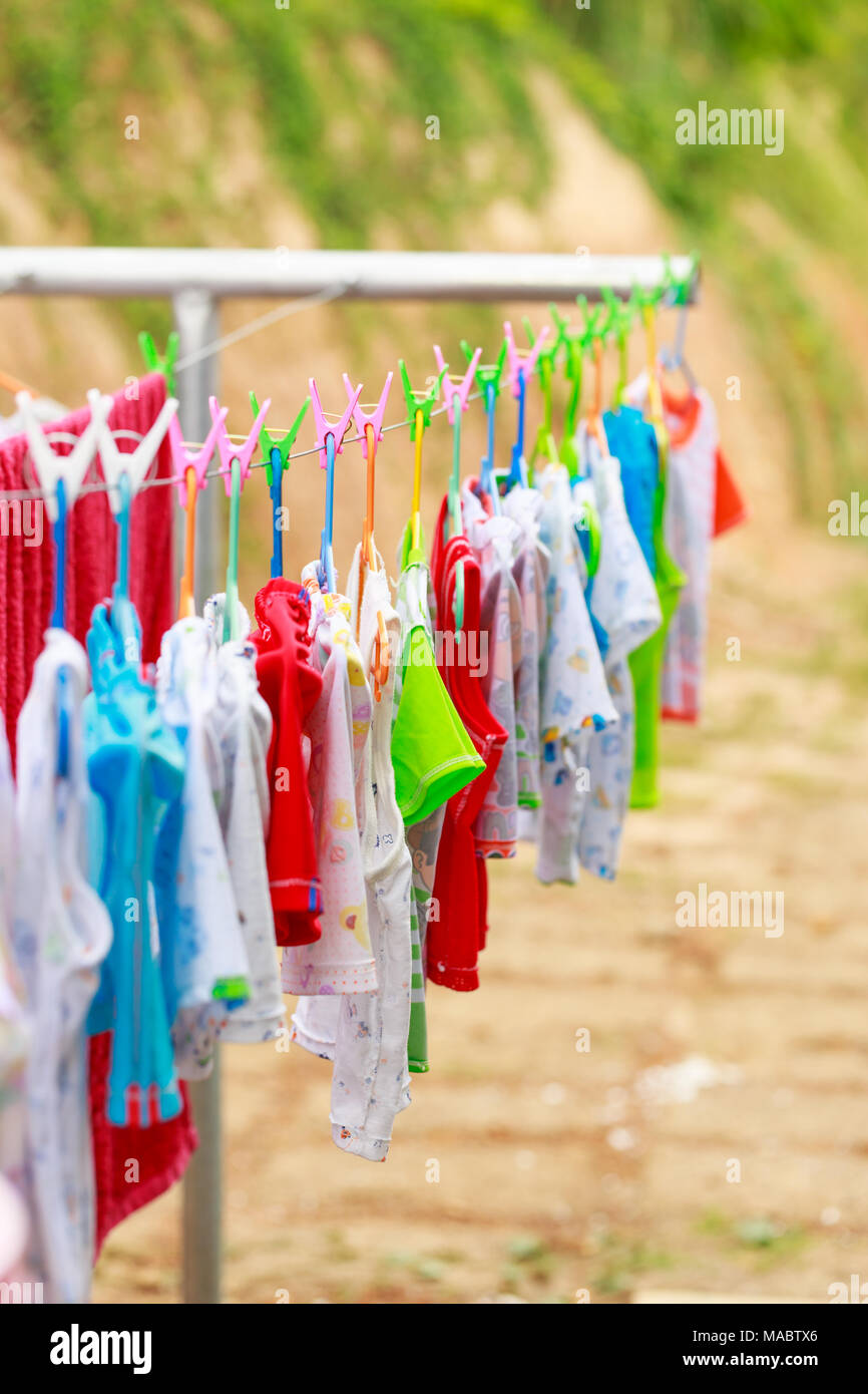 colorful of laundry pins and hanged clothes drying Stock Photo - Alamy