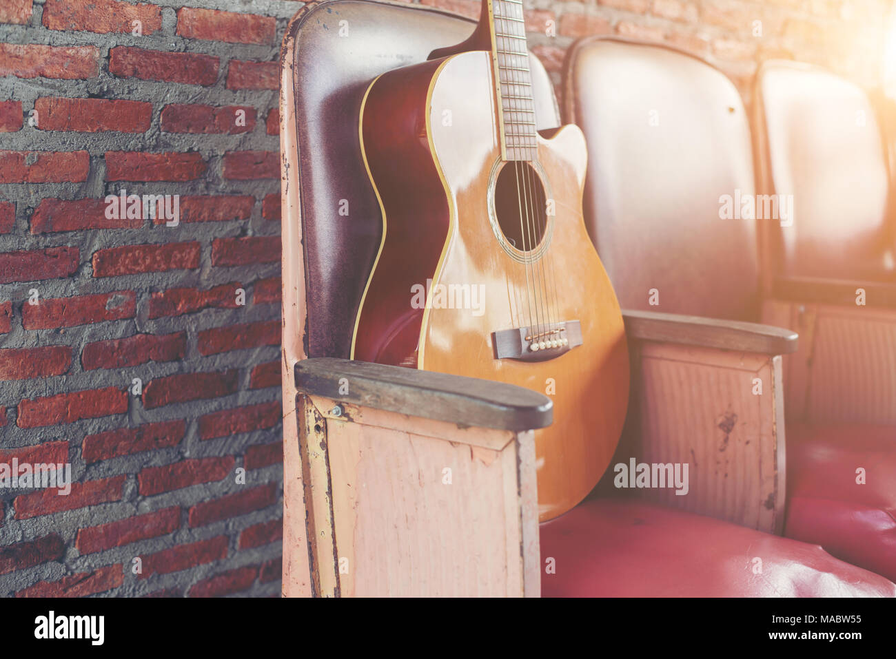 classical guitar with brick background horizontal Stock Photo - Alamy