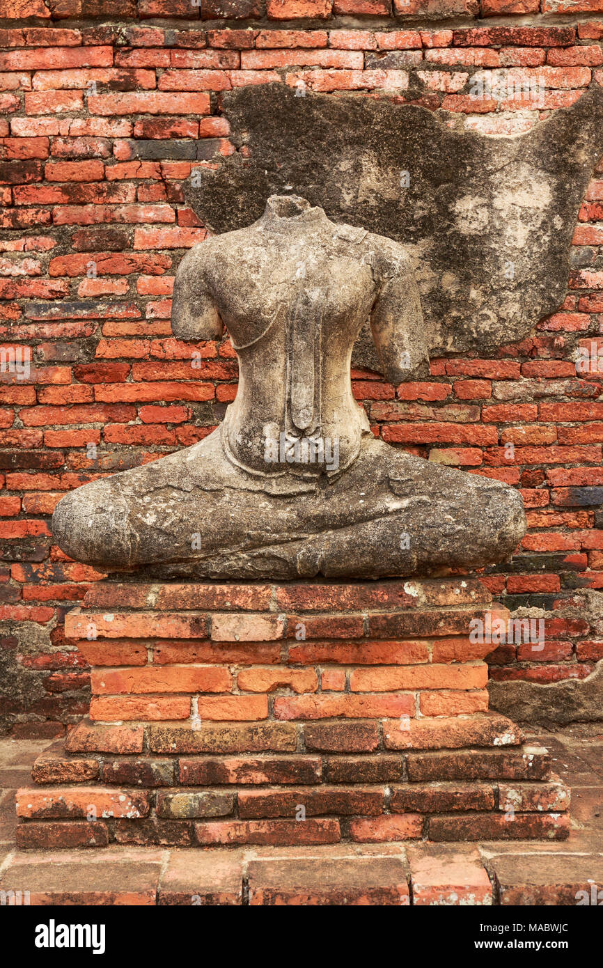 The broken Buddha statues on old brick wall in Wat Chaiwatthanaram ...