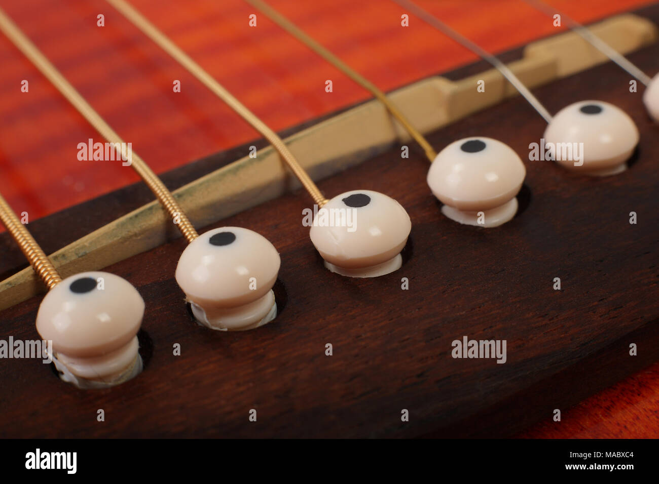 Musical instrument - bridge pin vintage acoustic guitar Stock Photo - Alamy