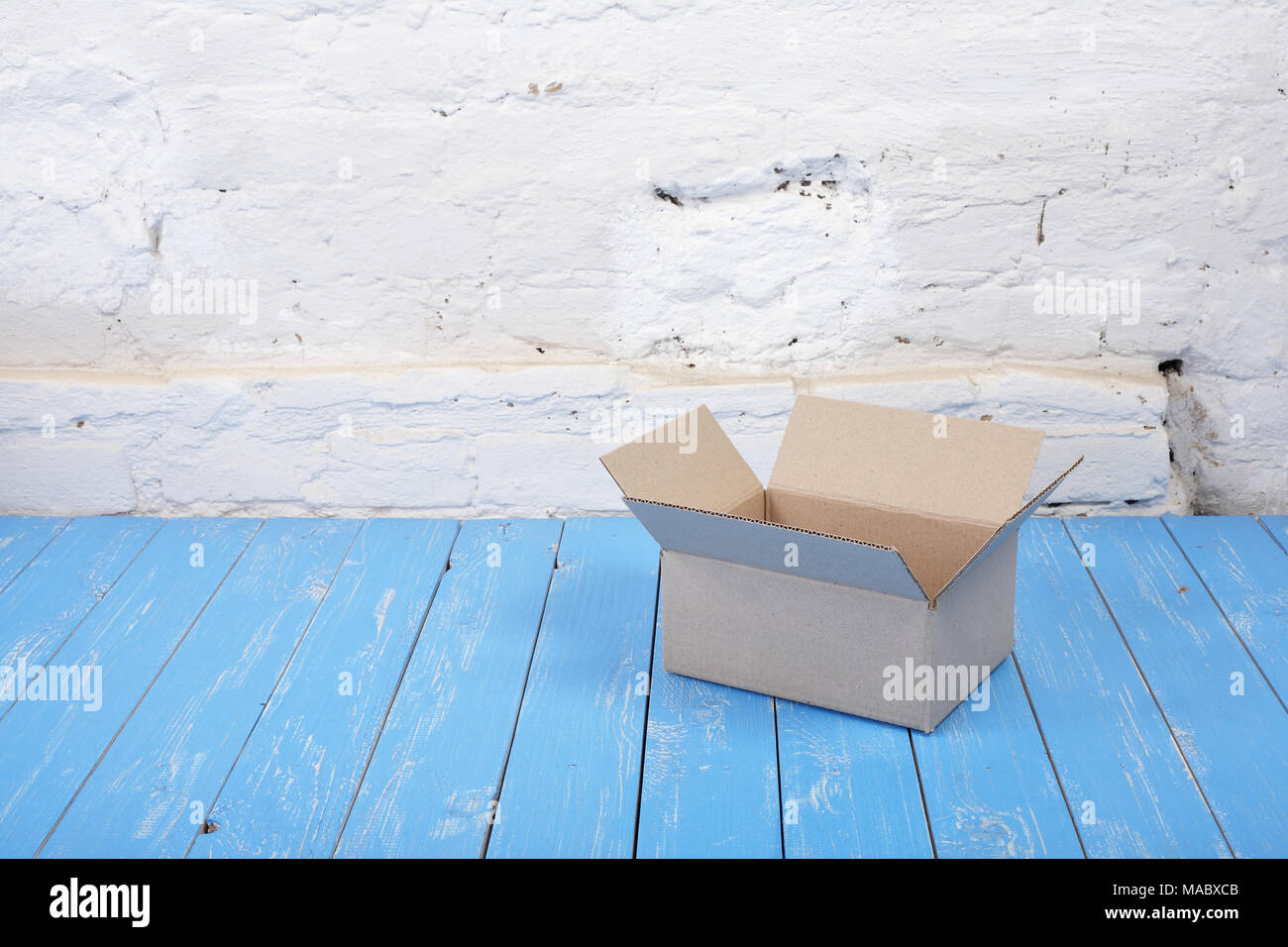 Postage and packing service - Open Package front view on a blue wood ...