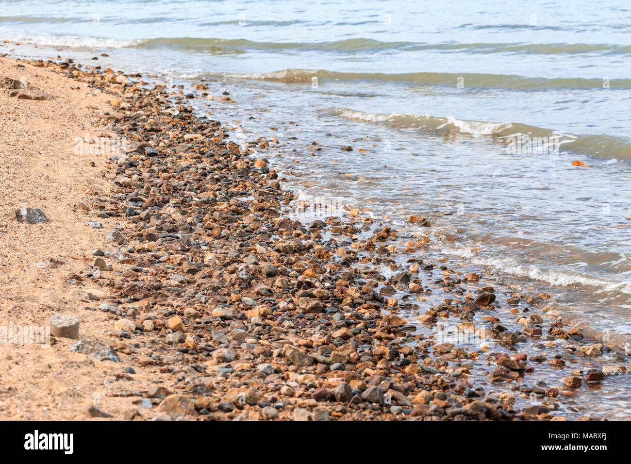 Stones on beach and sea water Stock Photo - Alamy