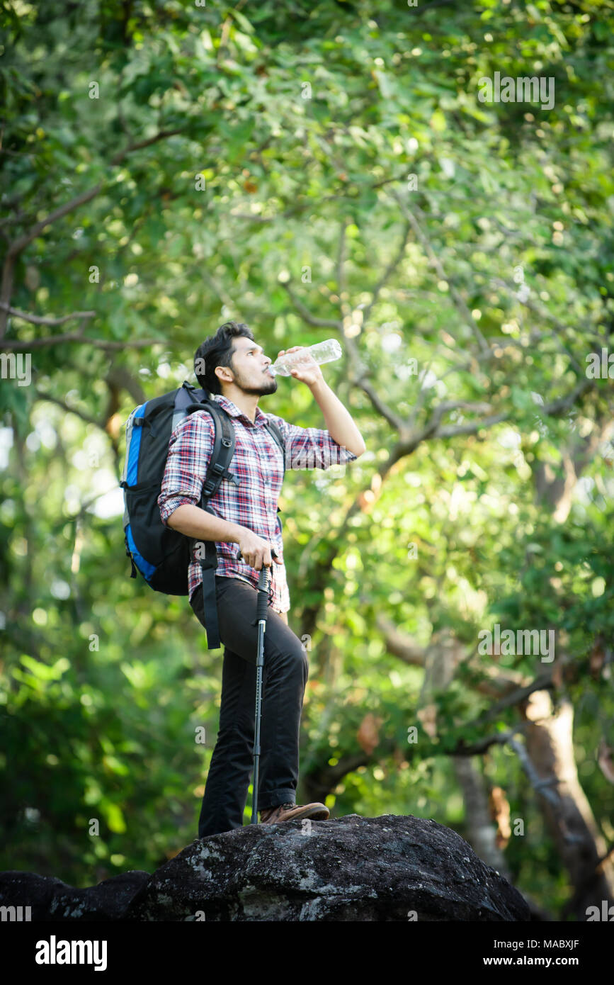 Young hiker relaxing on top of a mountain, Enjoy nature and adventure ...