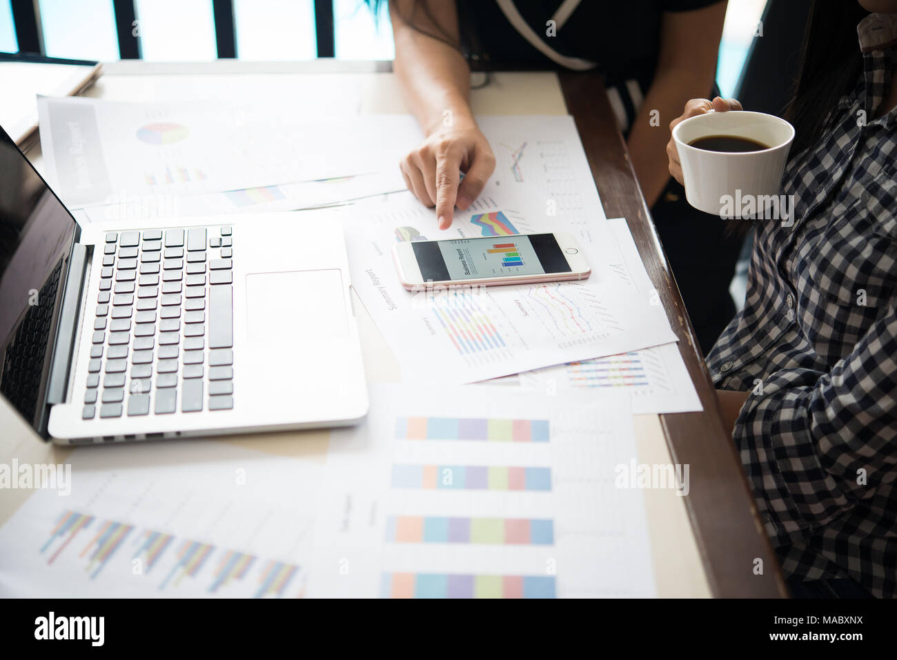 Business people at work on stock market charts in office. Meeting ...