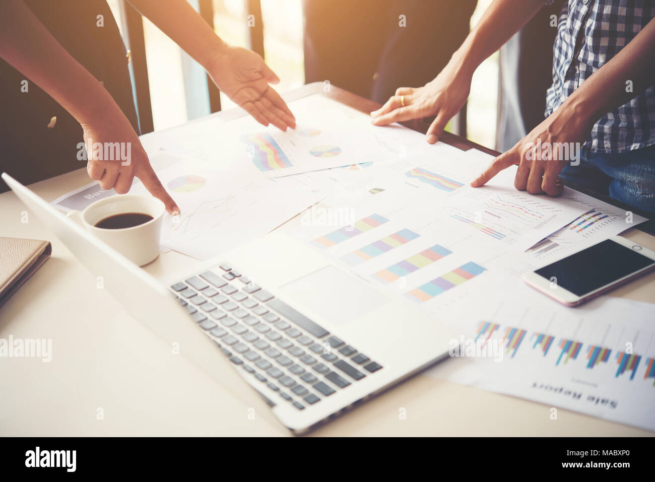 Business people at work on stock market charts in office. Meeting ...