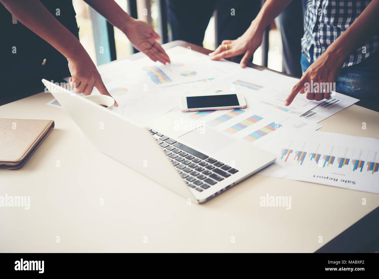 Business people at work on stock market charts in office. Meeting ...