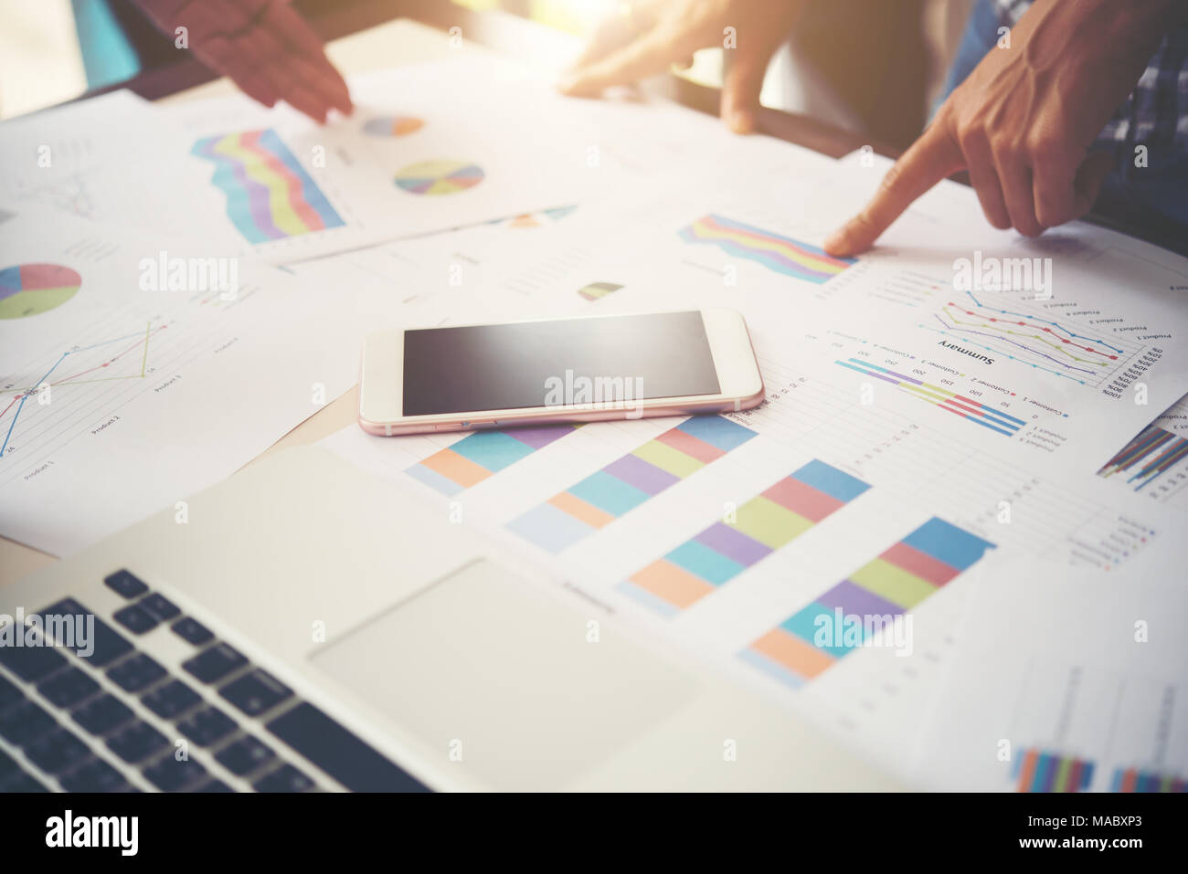 Business people at work on stock market charts in office. Meeting ...