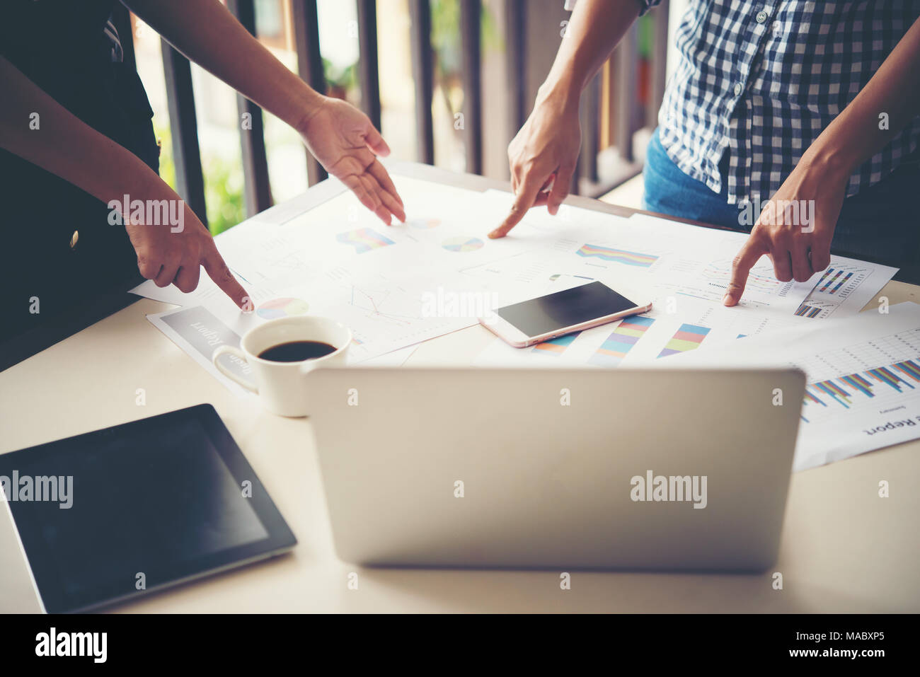 Business people at work on stock market charts in office. Meeting ...