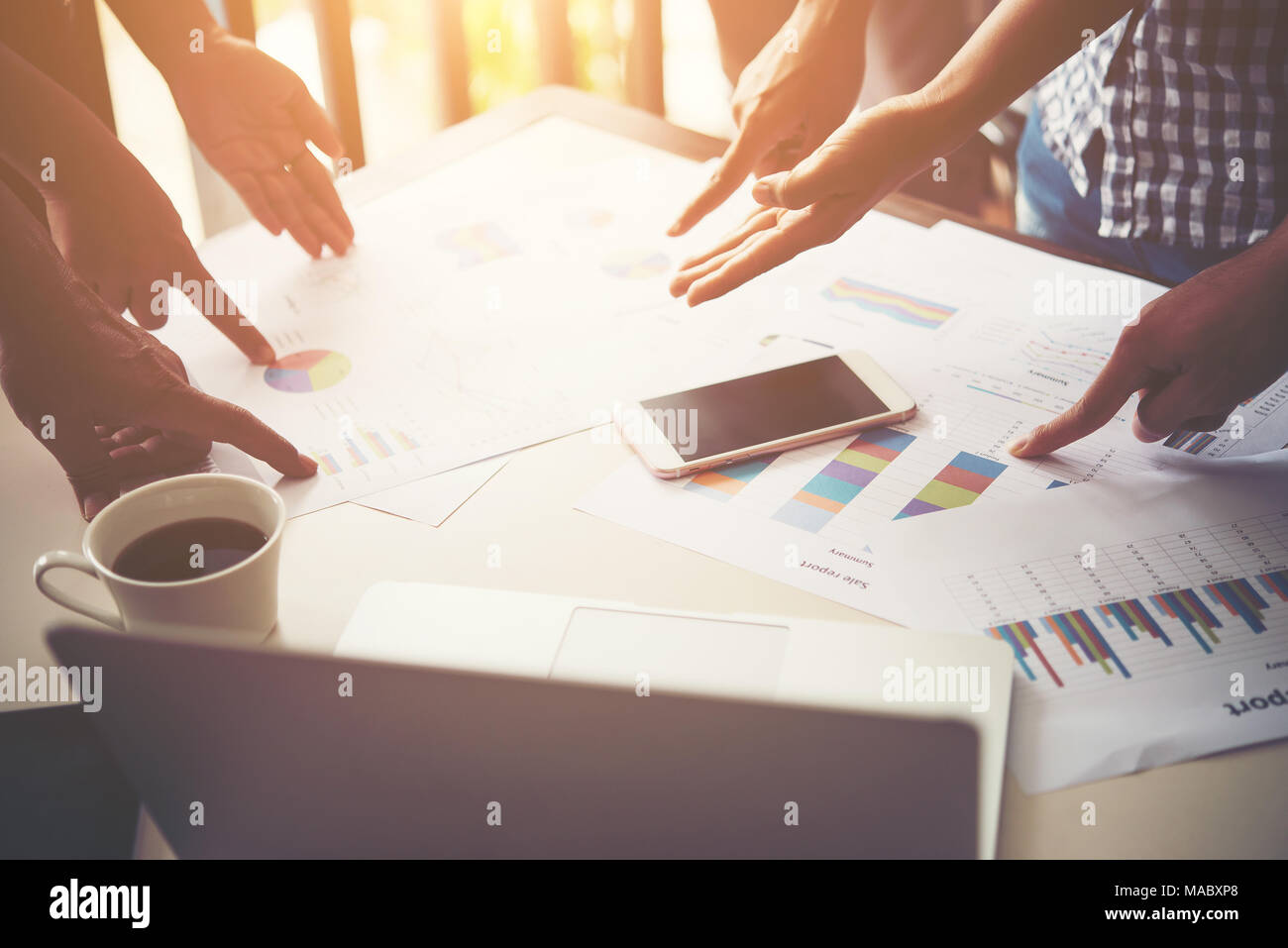 Business people at work on stock market charts in office. Meeting ...