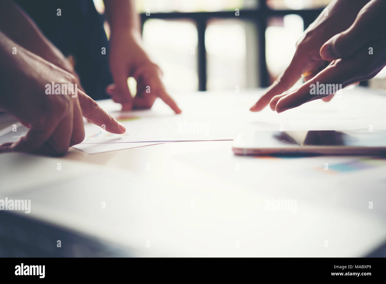 Business people at work on stock market charts in office. Meeting ...
