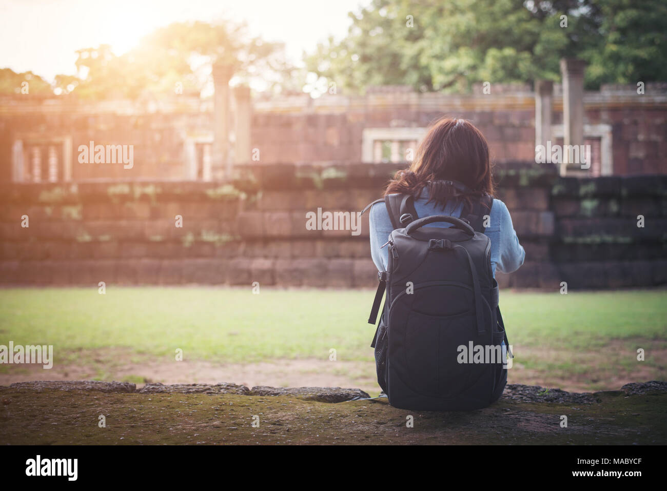 Young attractive woman photographer tourist with backpack coming to ...