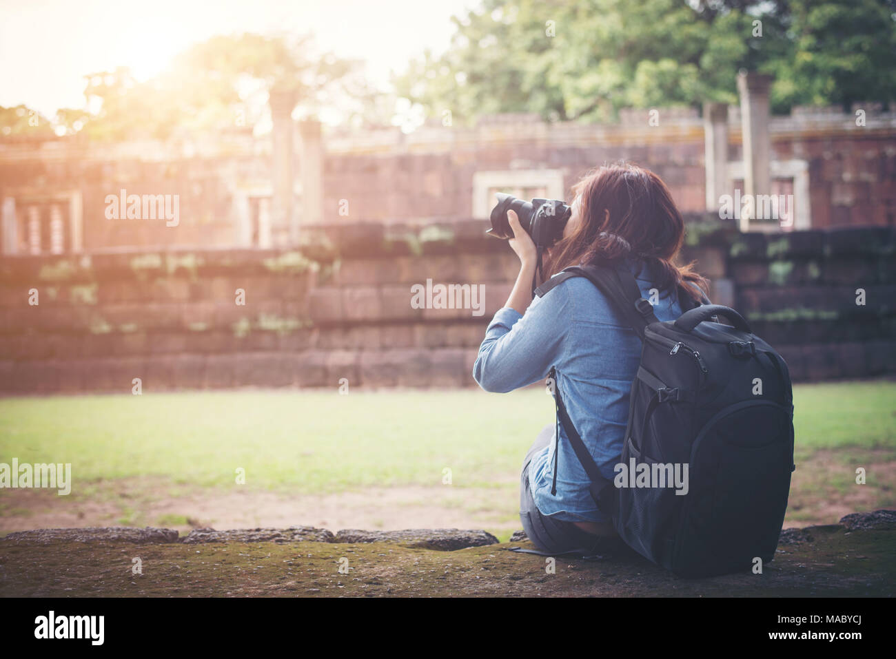 Young attractive woman photographer tourist with backpack coming to ...