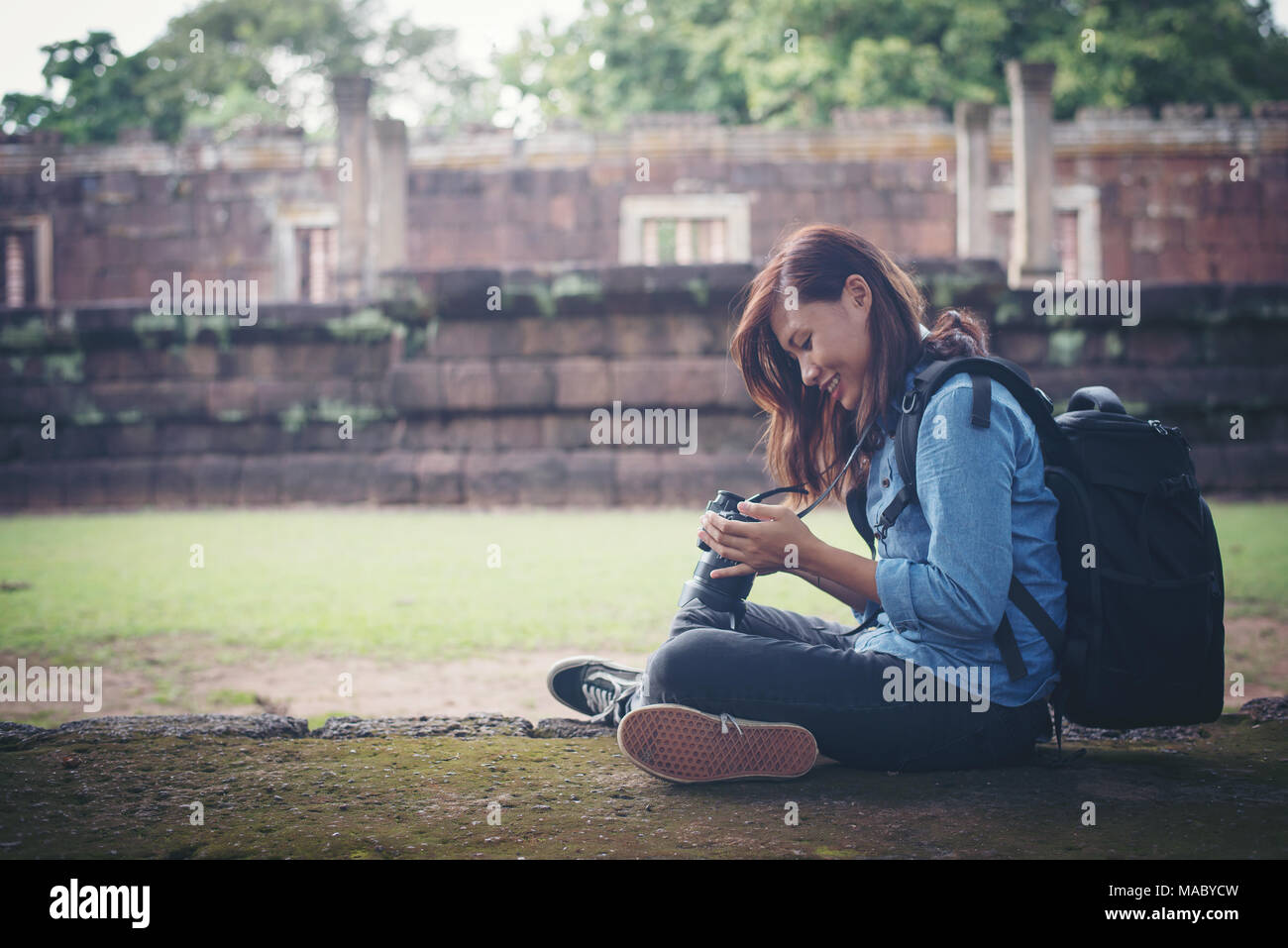 Young attractive woman photographer tourist with backpack coming to ...