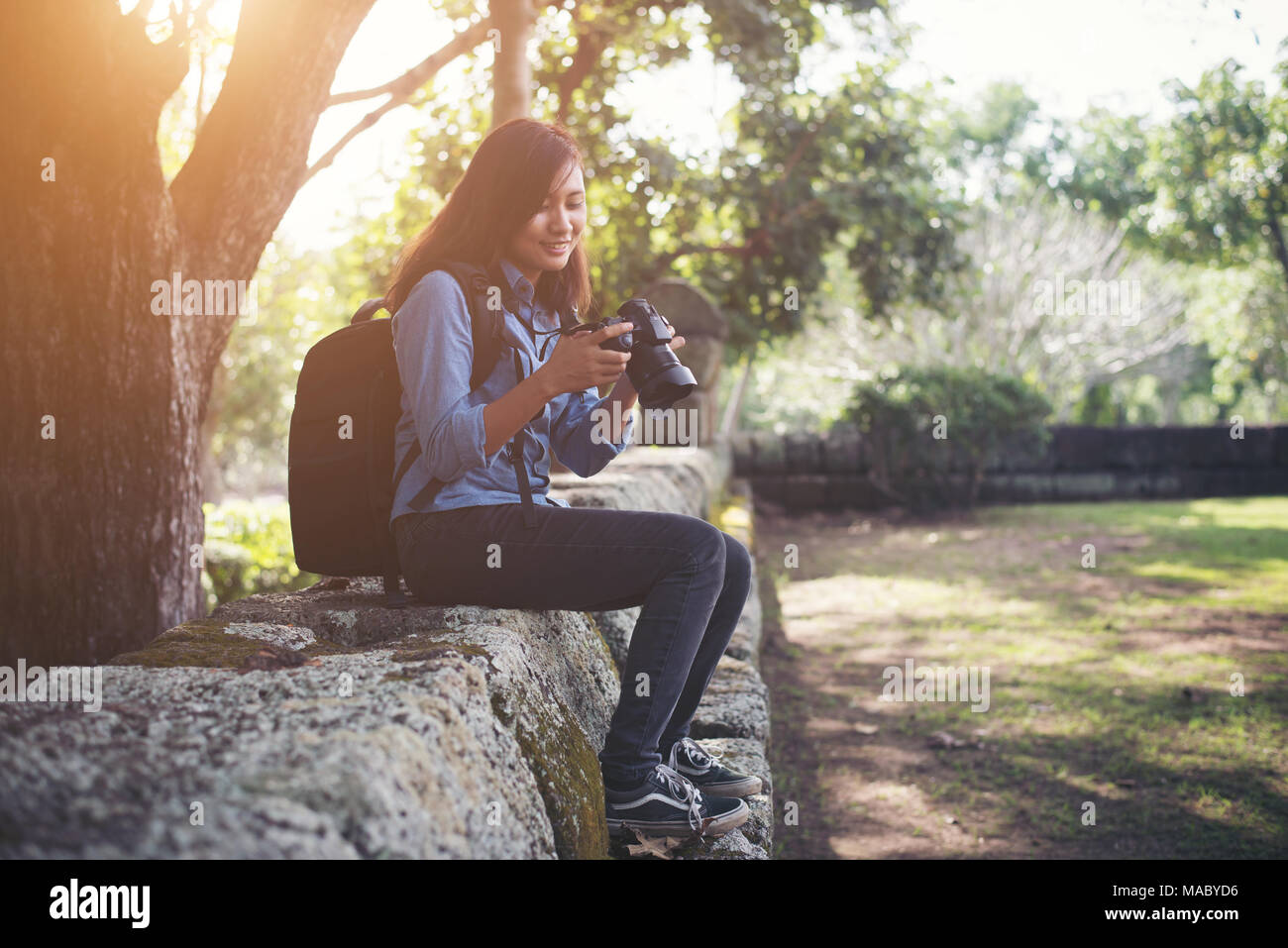 Young attractive woman photographer tourist with backpack coming to ...