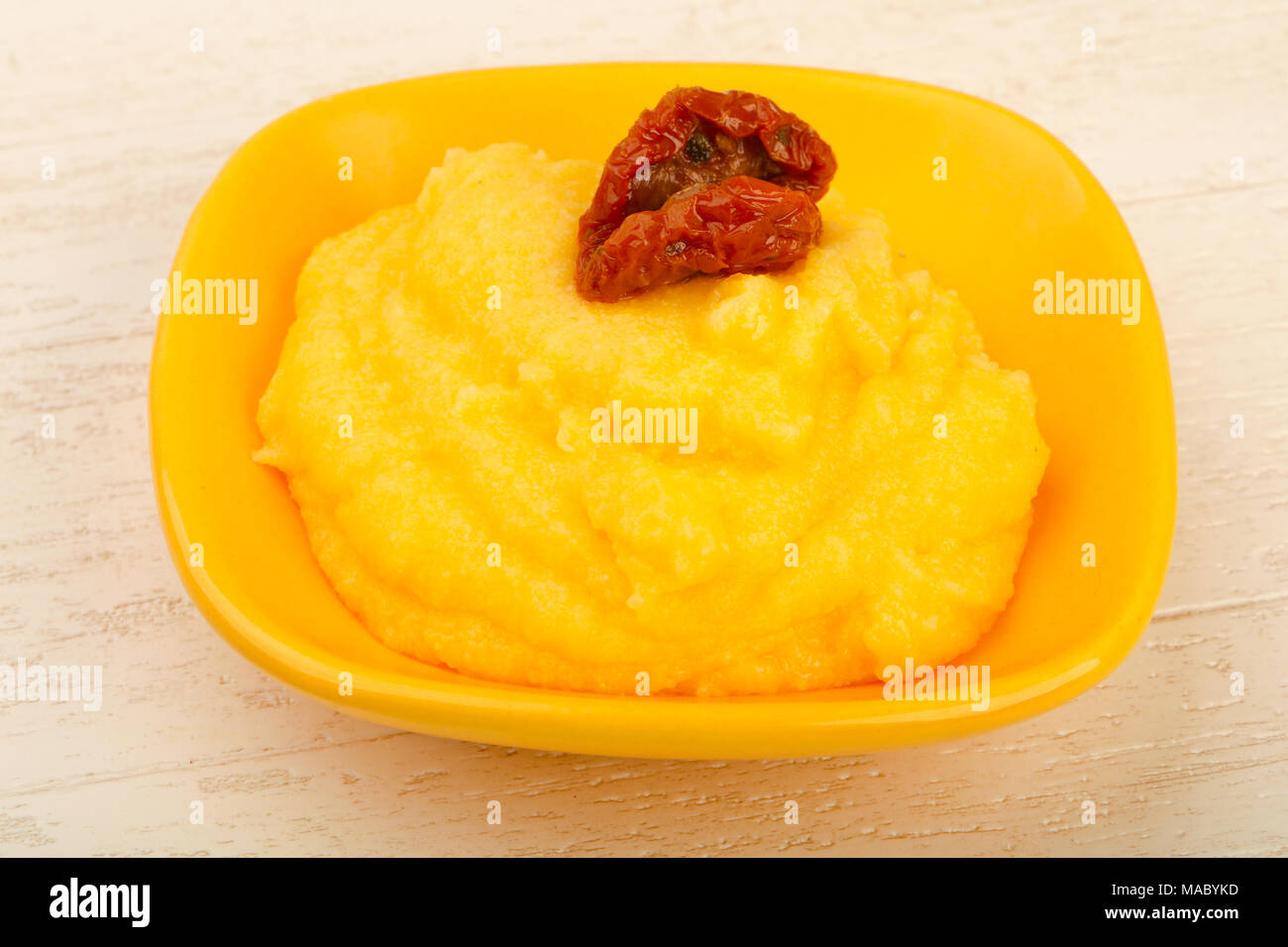 Polenta with dry tomato Stock Photo - Alamy