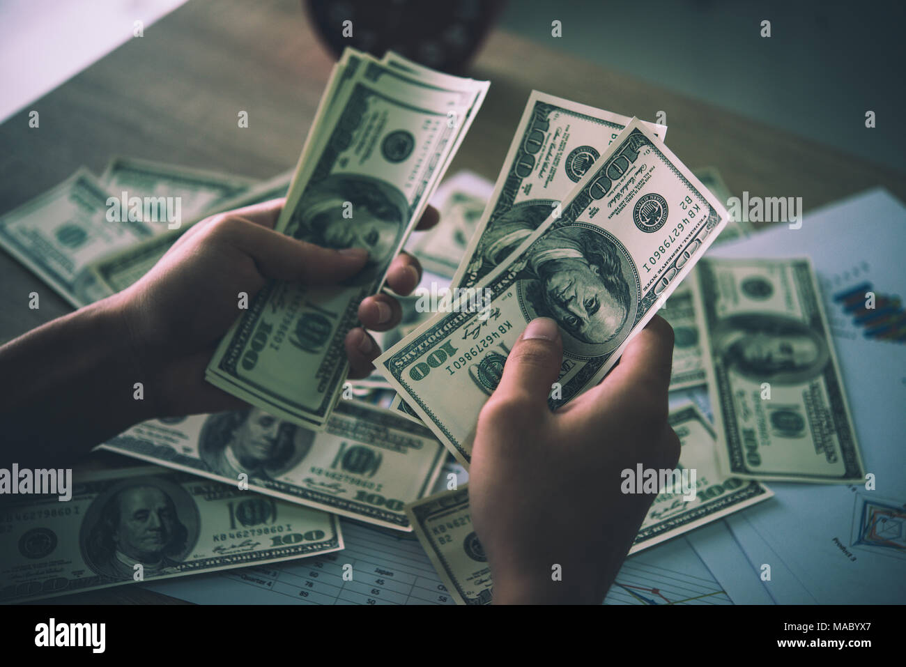Working place of trader. The table covered by cash notes, keyboard and ...