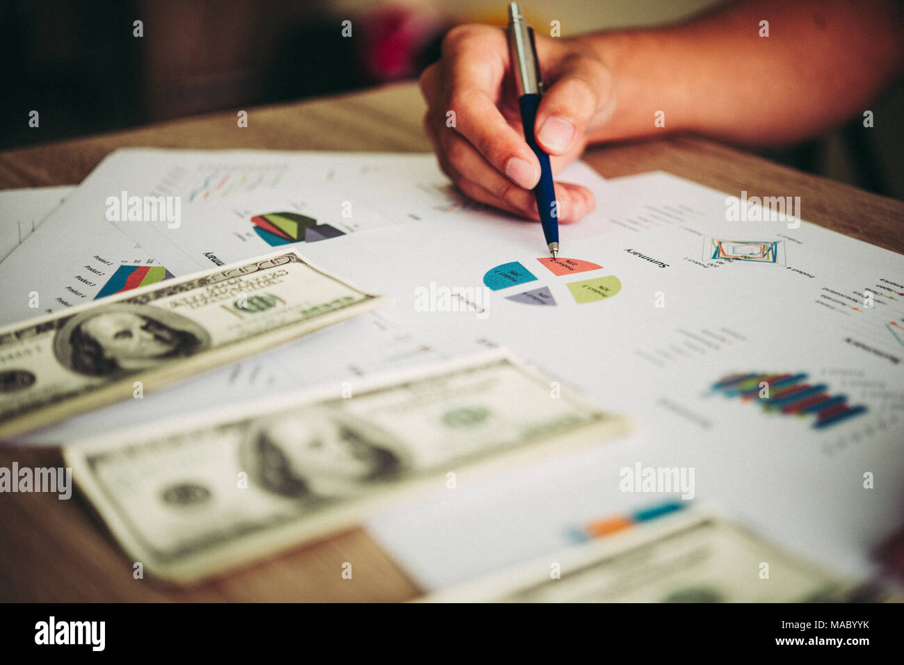 Working place of trader. The table covered by cash notes, keyboard and ...