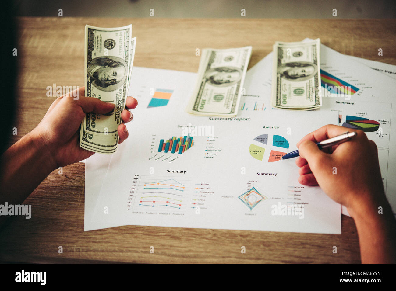 Working place of trader. The table covered by cash notes, keyboard and ...