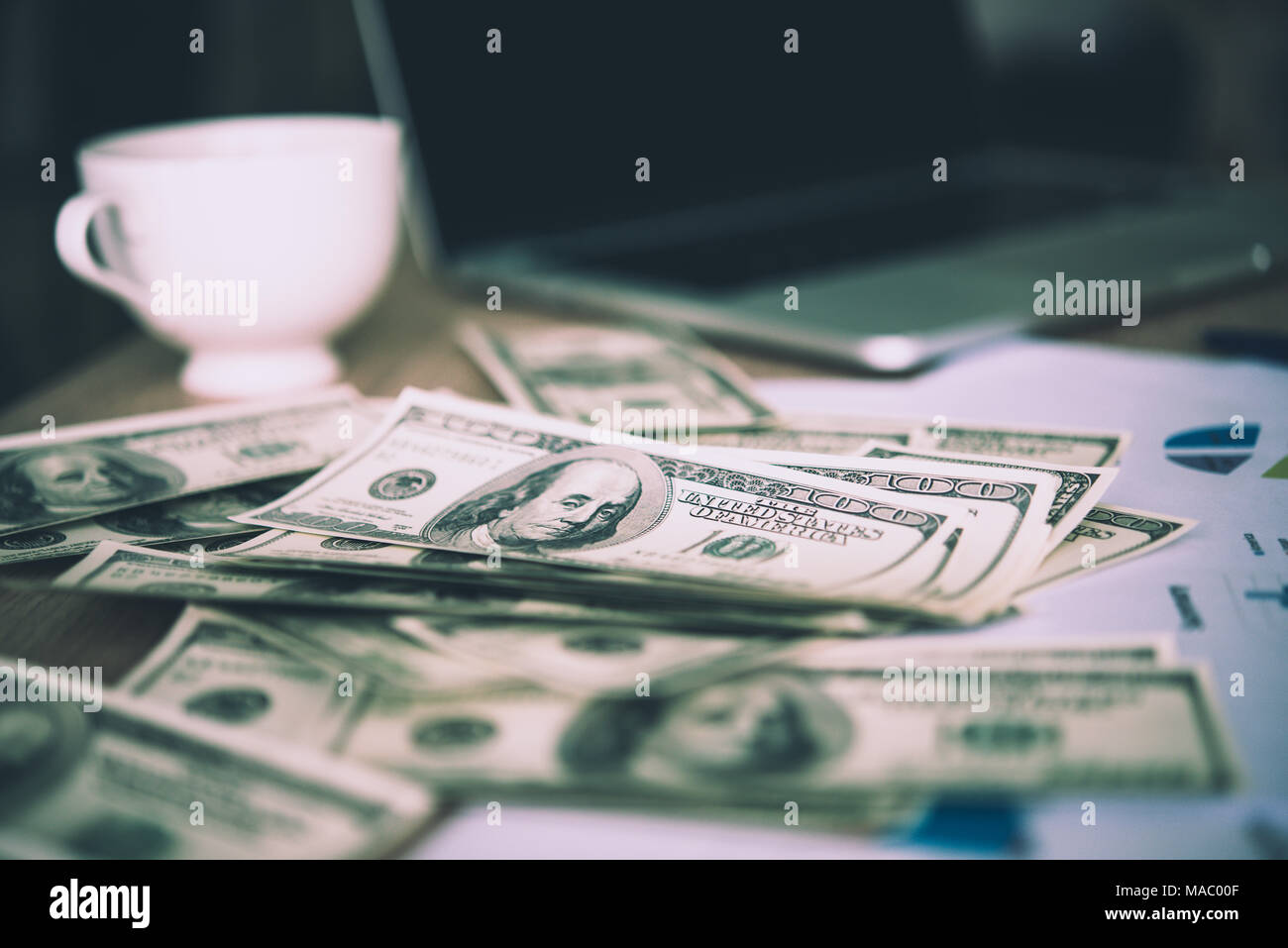 Working place of trader. The table covered by cash notes, keyboard and ...
