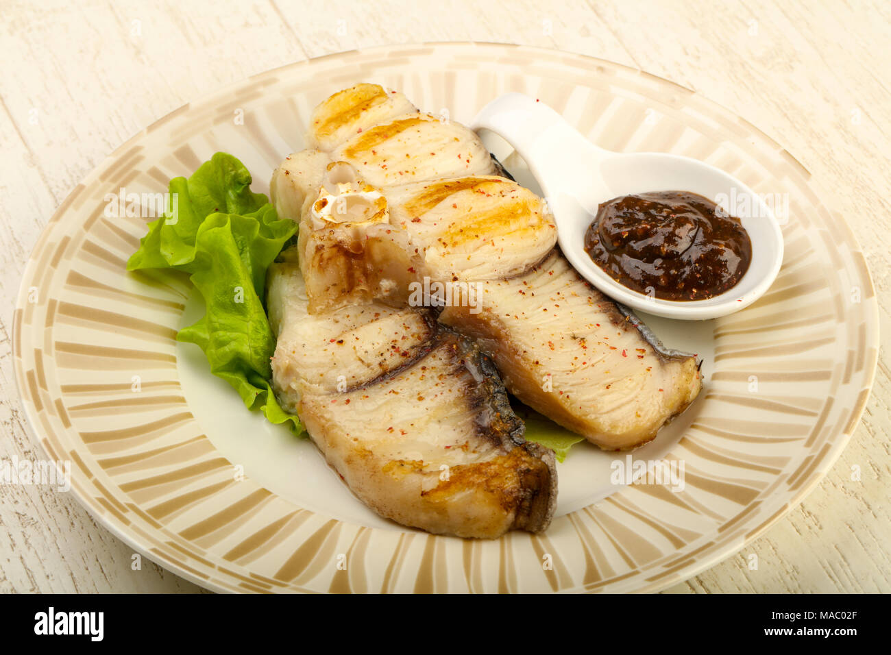 Grilled shark steak with pepper sauce and salad leaves Stock Photo - Alamy