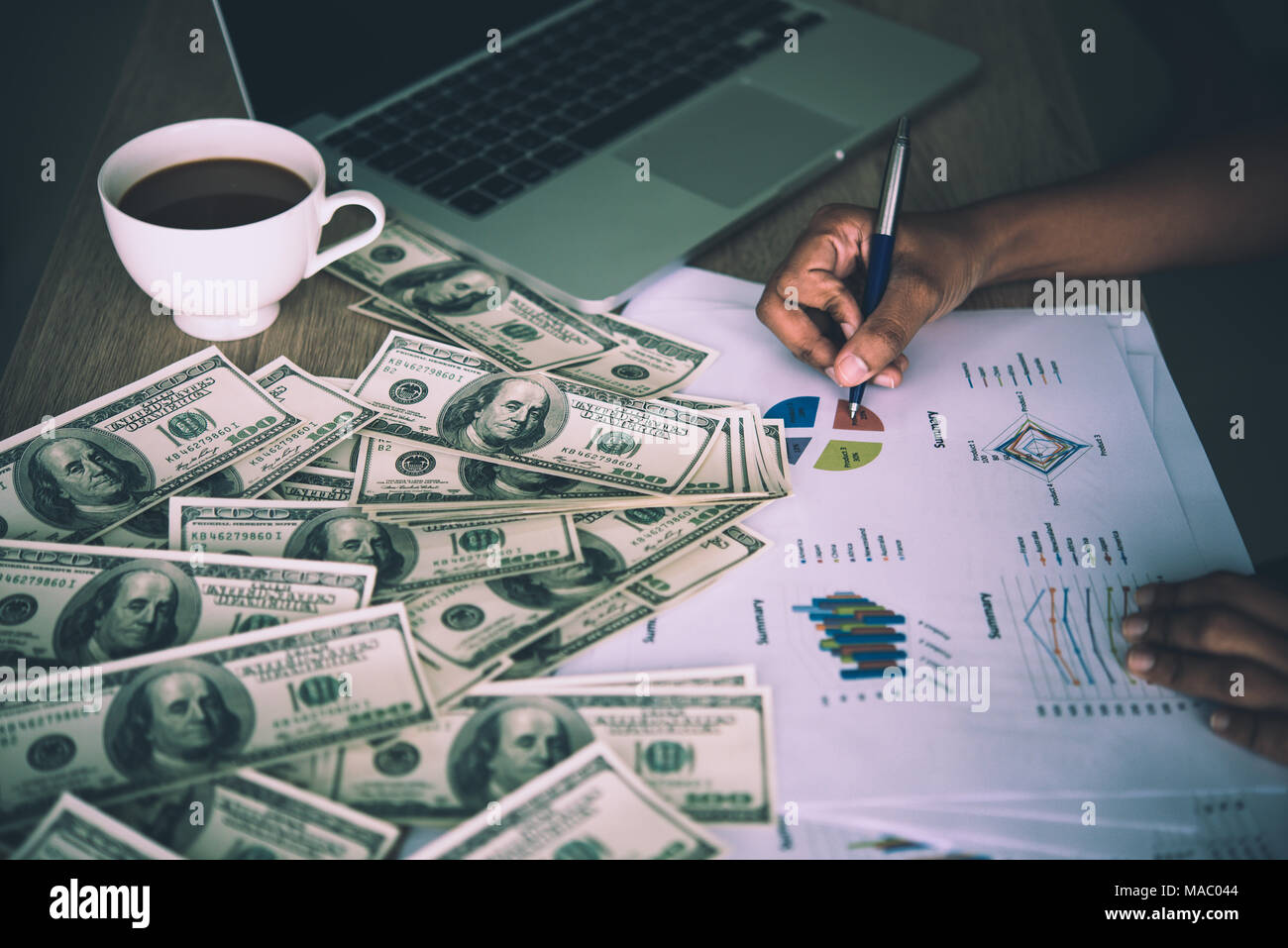 Working place of trader. The table covered by cash notes, keyboard and ...