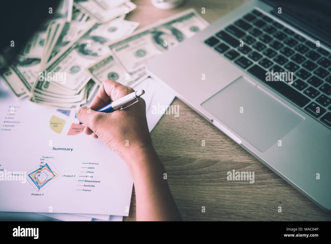 Working place of trader. The table covered by cash notes, keyboard and ...