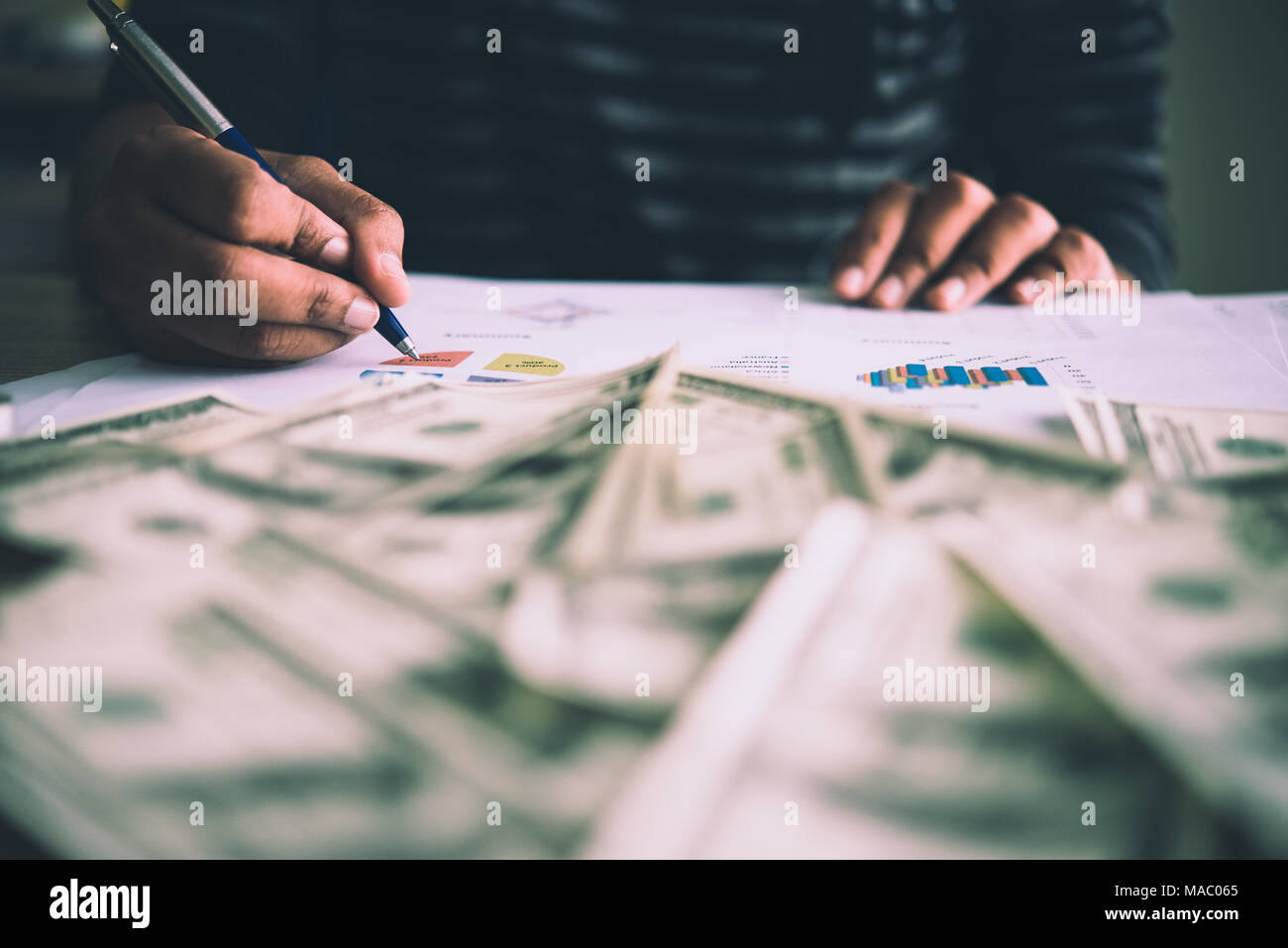 Working place of trader. The table covered by cash notes, keyboard and ...