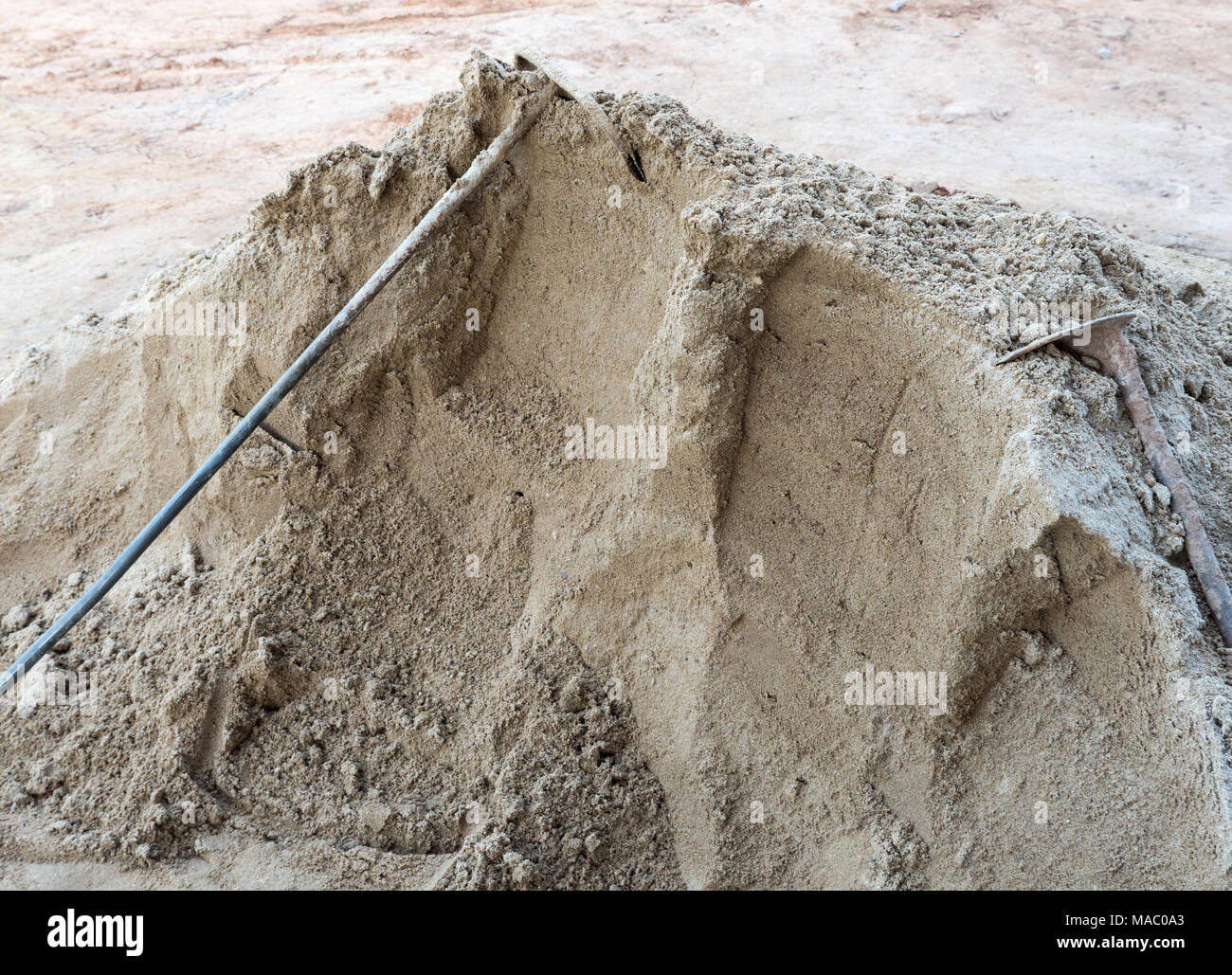 Old metal spade on the sand pile for use in the construction site Stock ...