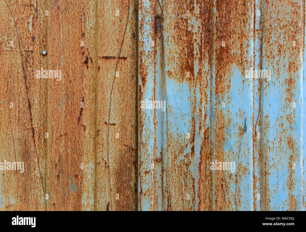 Colourful but rusty metal fence by a small construction site in Beijing ...