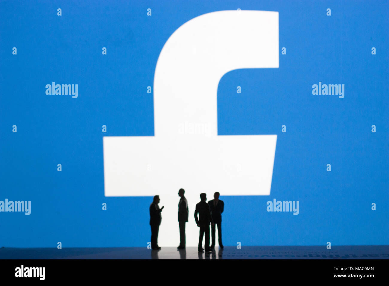 Facebook logo with models of people in foreground Stock Photo - Alamy