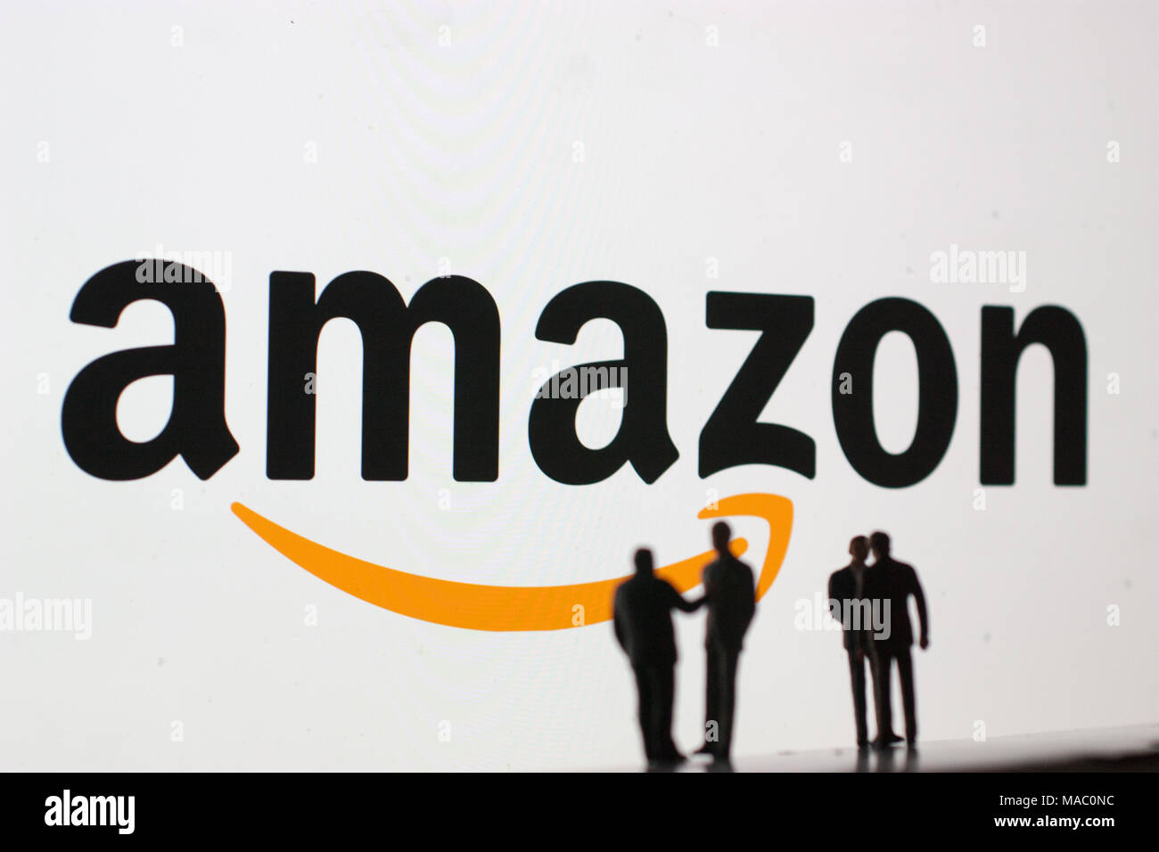 Amazon logo with models of people in foreground Stock Photo - Alamy