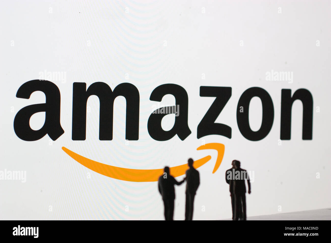 Amazon logo with models of people in foreground Stock Photo - Alamy