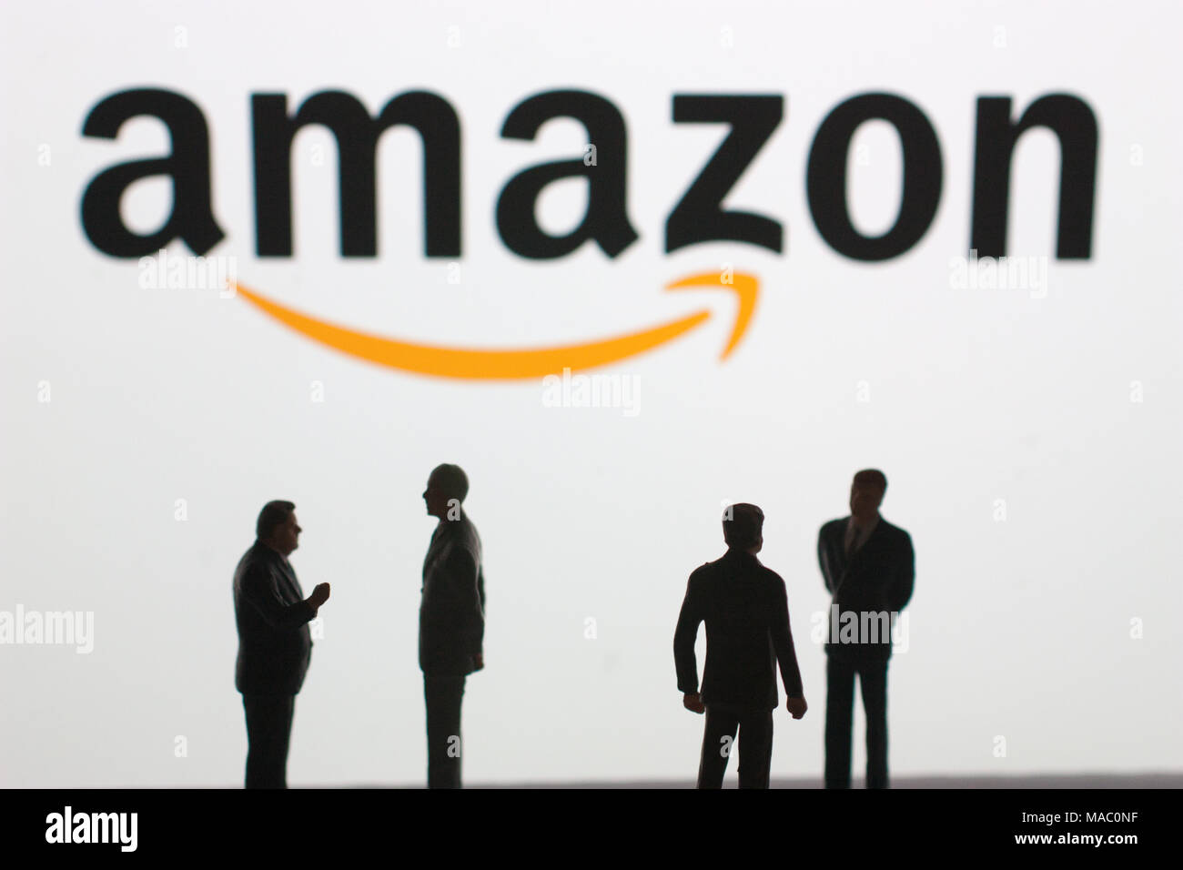 Amazon logo with models of people in foreground Stock Photo - Alamy