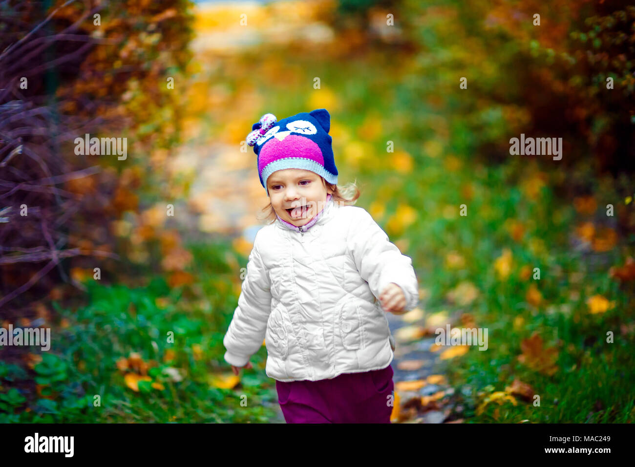 Cheerful girl on path in park Stock Photo - Alamy