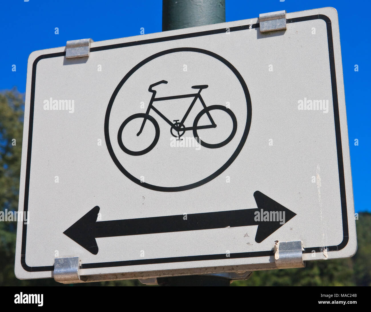 Road sign with a bike with arrows Stock Photo - Alamy