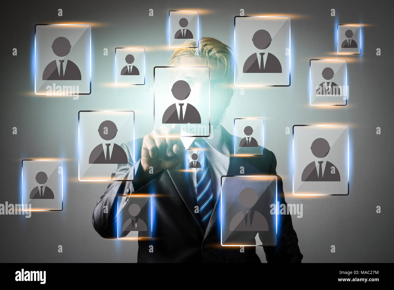 Young businessman pointing digital people icon network application on ...