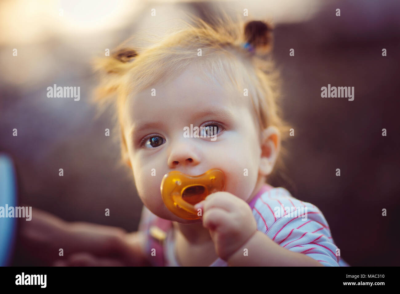 Adorable little girl with dummy Stock Photo - Alamy