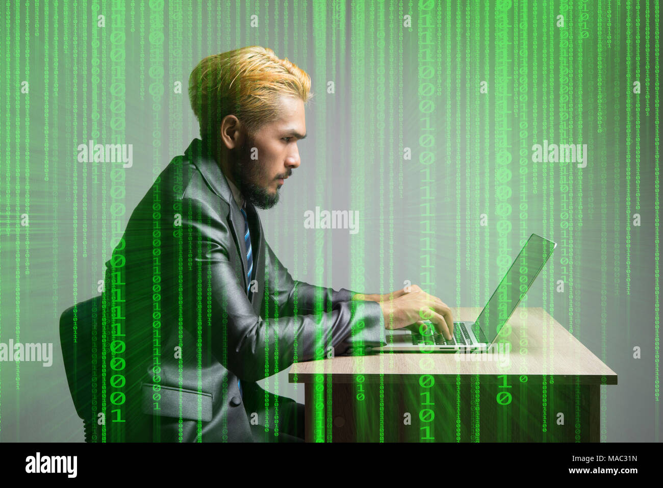 Business man sitting in front of laptop keyboard with binary code on screen background Stock ...