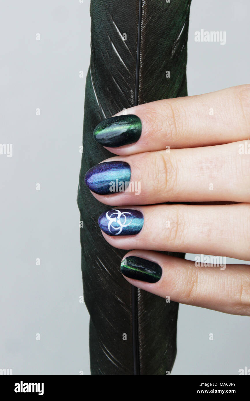 hand of a young girl with green manicure, which shows a sign of ...