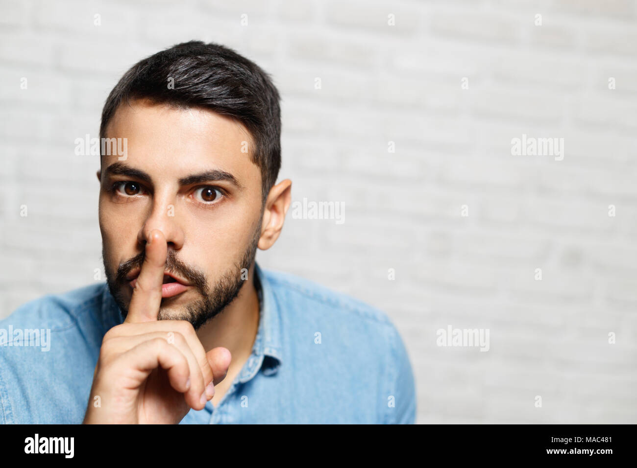 Portrait of Italian man whispering secrets. Guy looking at camera and ...