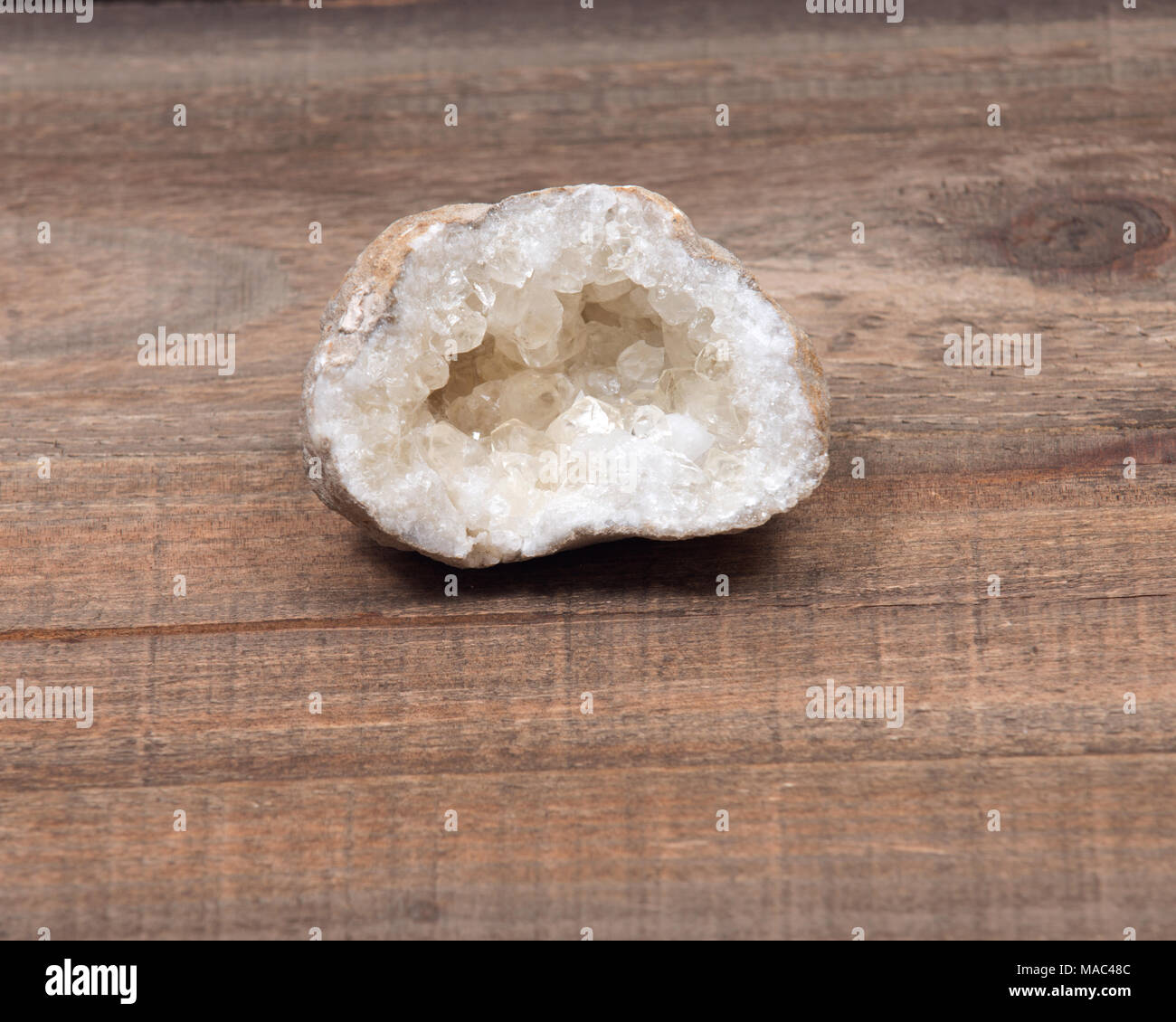 Natural raw citrine geode on wooden background Stock Photo - Alamy