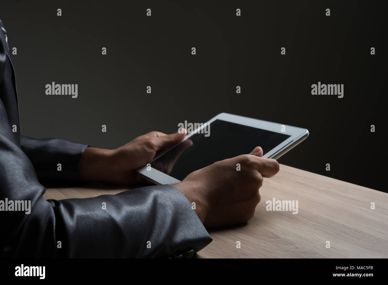 Businessman holding tablet and looking on a blank screen Stock Photo ...