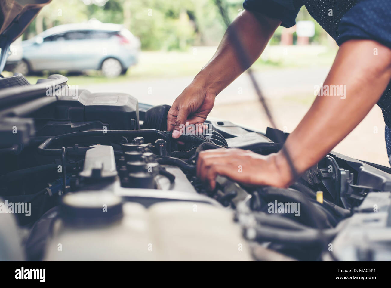 Man with checking car engine Stock Photo - Alamy