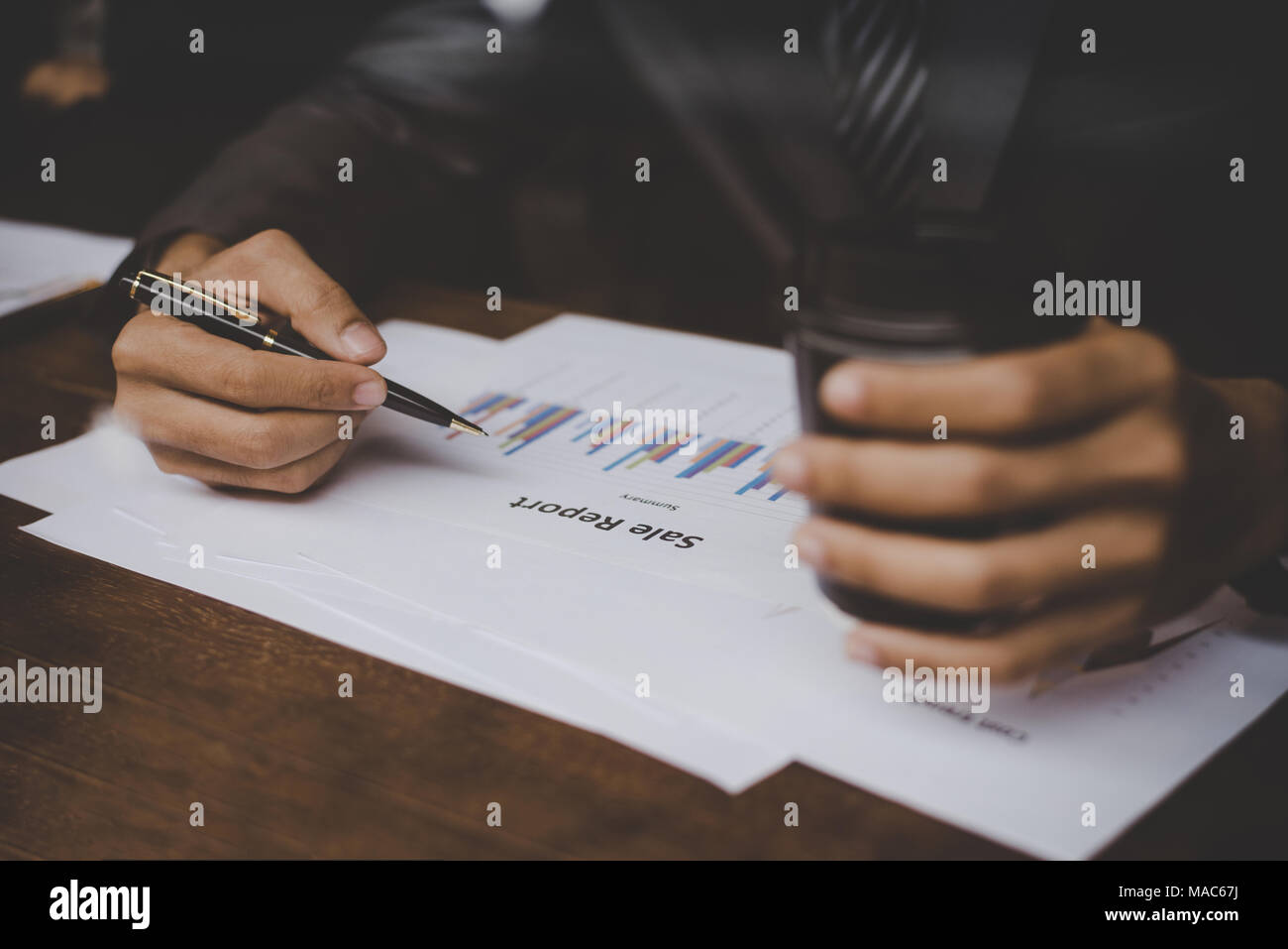 Businessman analysis with his work at cafe Stock Photo - Alamy