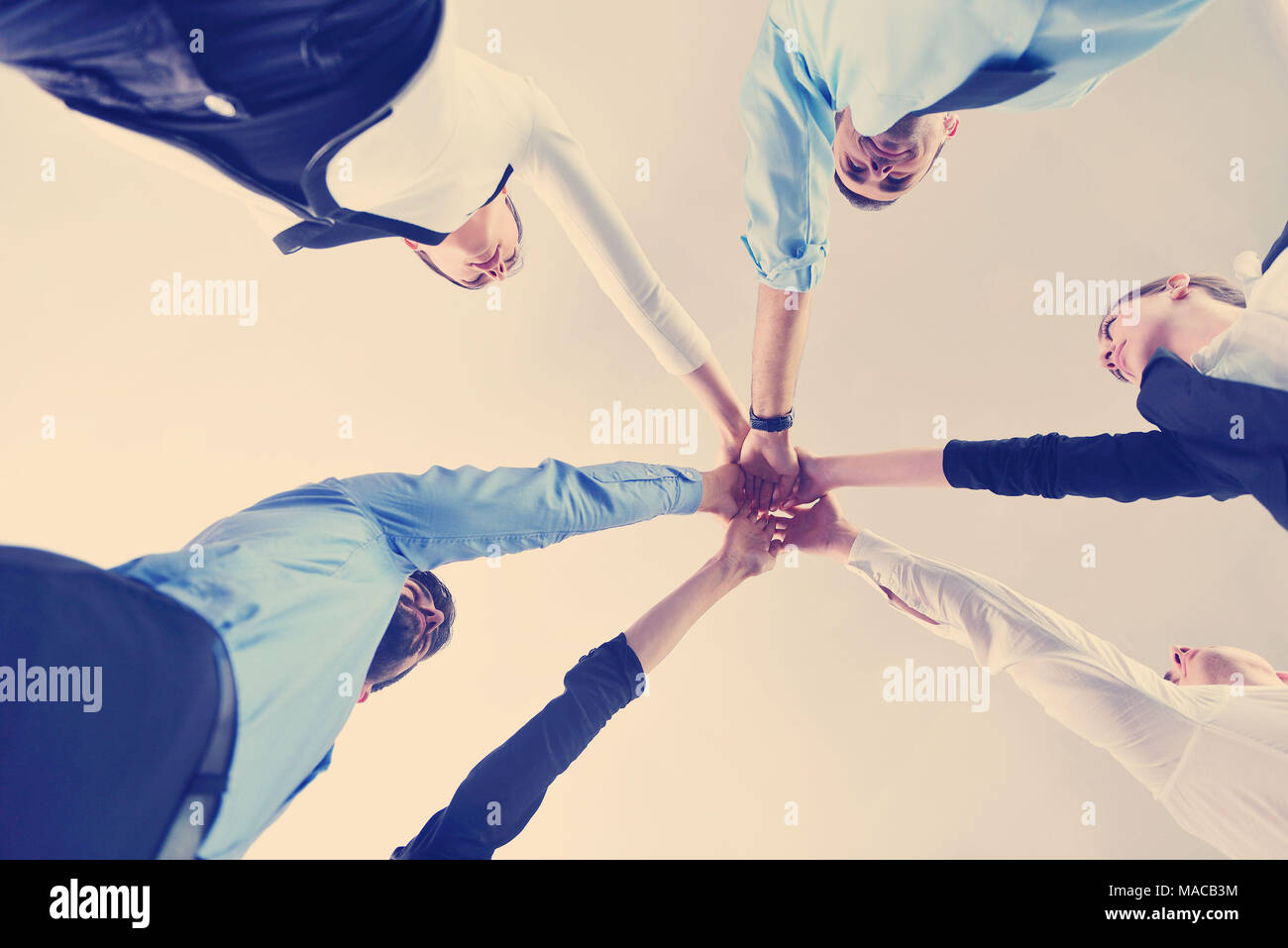business people group joining hands and representing concept of friendship and teamwork, low ...