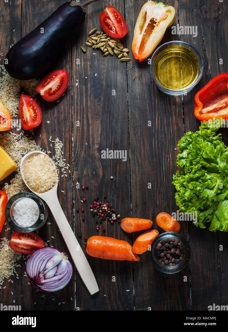 Organic vegetarian ingredients, olive oil and rice on rustic wooden ...