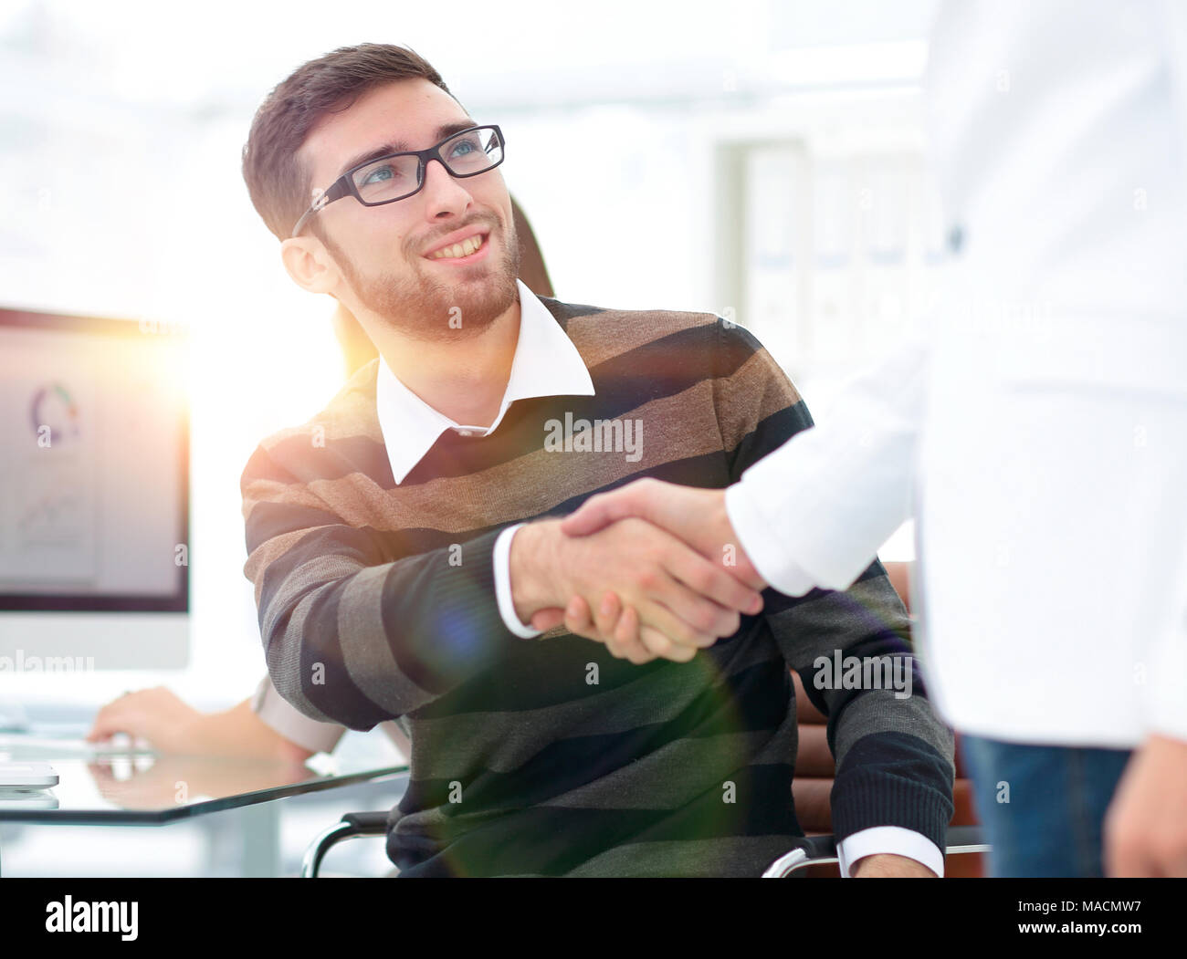 handshake between colleagues in the workplace Stock Photo - Alamy